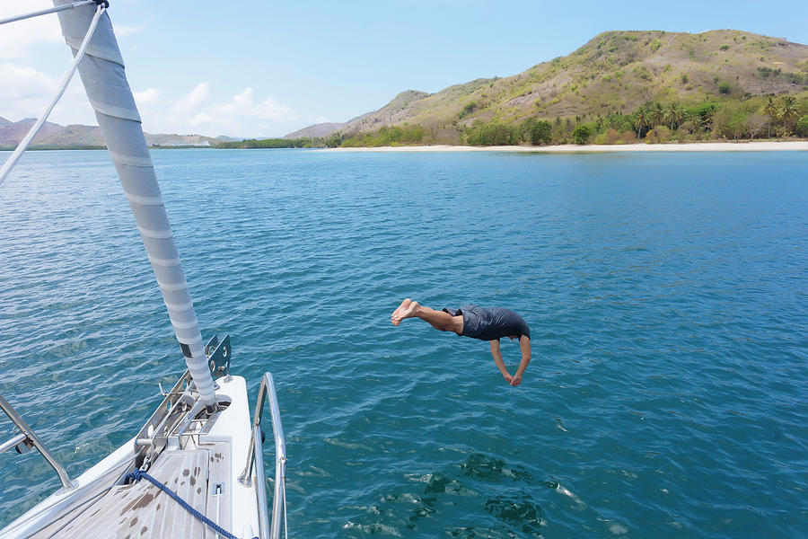Man Diving In Water From Boat, Lombok Photograph by Konstantin Trubavin - Fine Art America