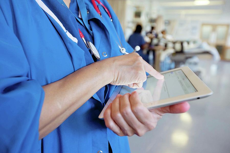 Doctor Using Tablet Computer #2 by Science Photo Library