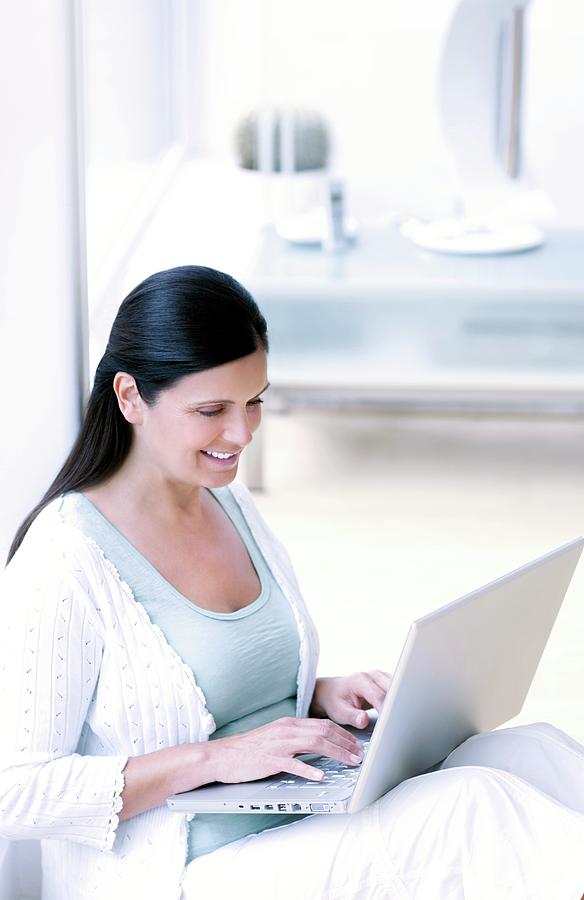 Woman Using A Laptop Photograph By Ian Hooton Science Photo Library