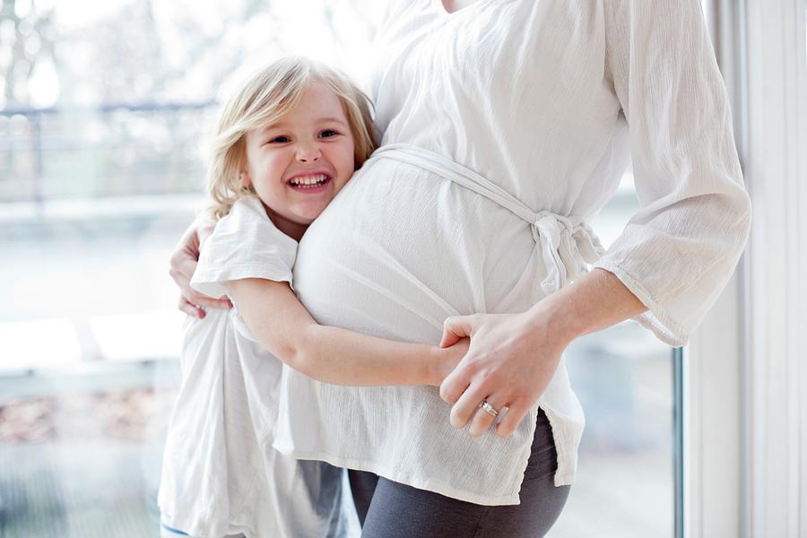 Girl With Pregnant Mother Photograph By Ian Hooton Science Photo