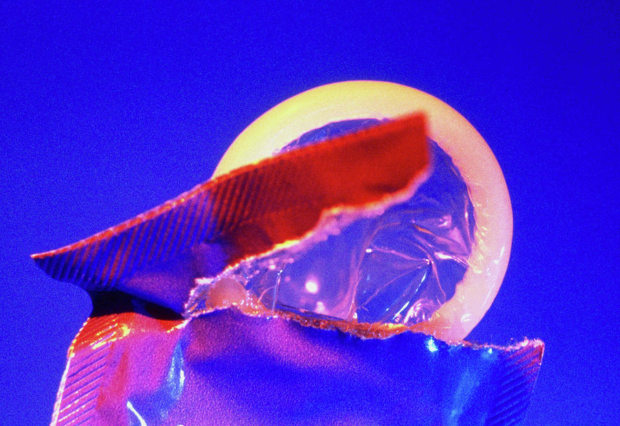 Condom Partly Projecting From An Opened Packet Photograph By Tony Craddockscience Photo Library