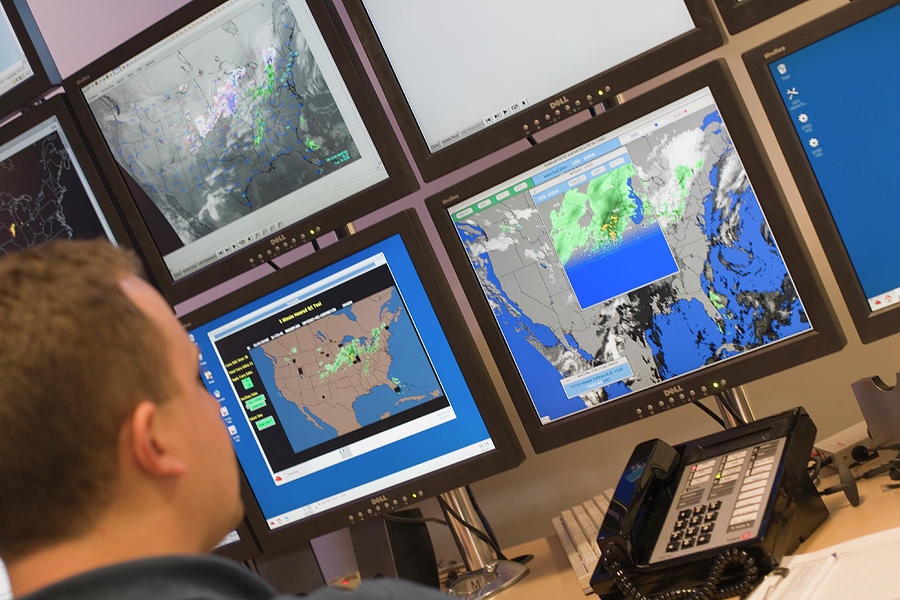 Meteorologist Studying Weather Patterns by Science Photo Library
