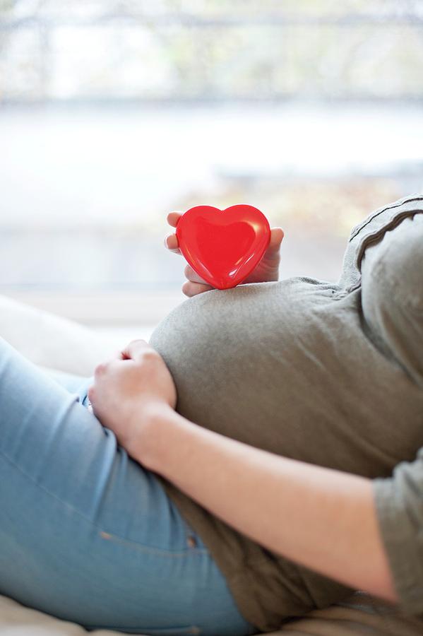 Pregnant Woman With Heart Shape On Tummy Photograph By Ian Hooton