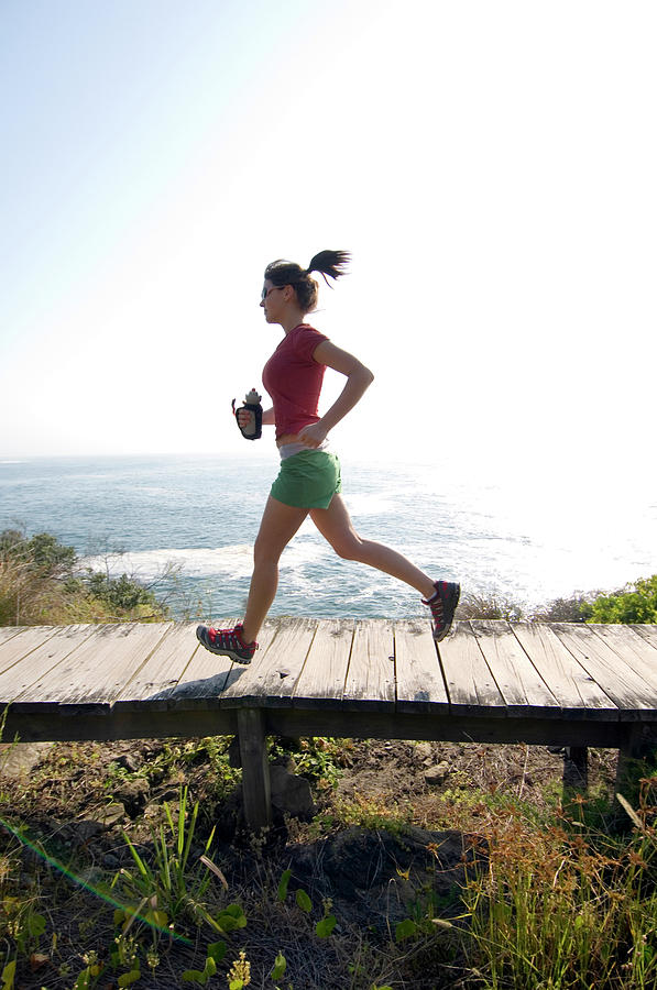 Runner On Bridge Along Ocean Trail Photograph by Lars Schneider | Fine ...