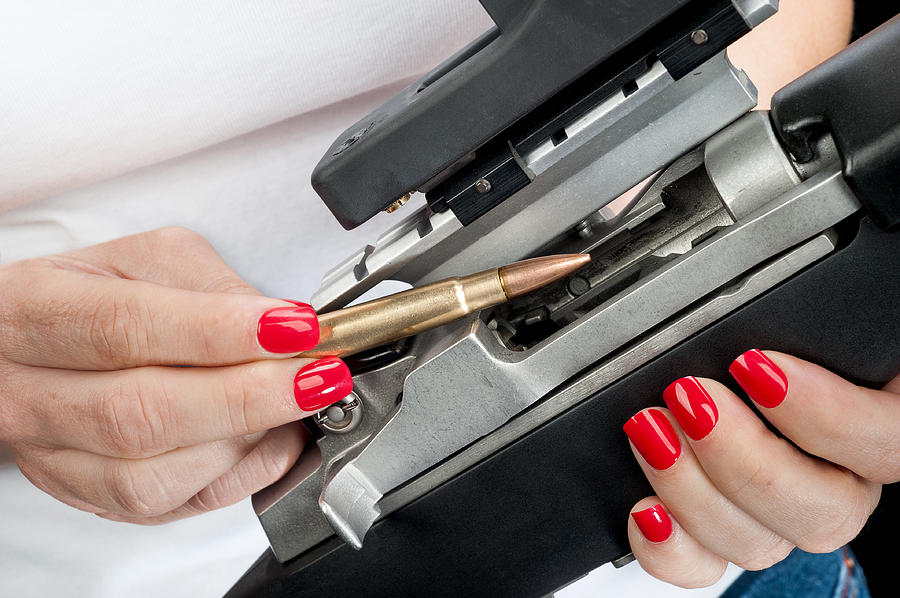 Woman loading rifle Photograph by Joe Belanger