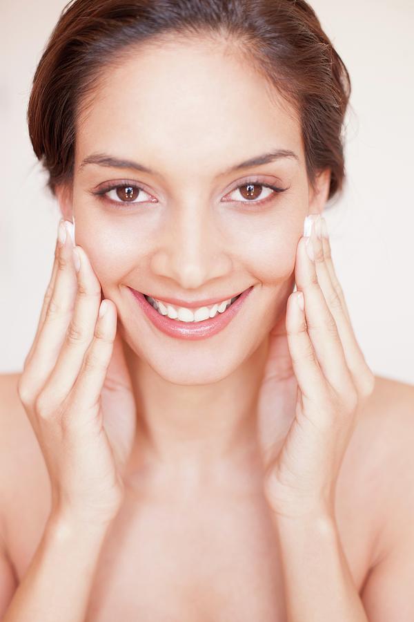 Woman Rubbing Cream Into Her Face Photograph By Ian Hooton Science