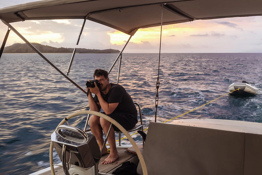 Young Man With Camera On Sailboat Photograph by Konstantin Trubavin - Fine Art America