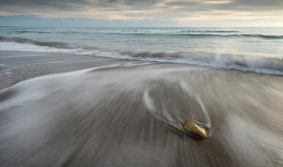 Pebbles in the beach and flowing sea water Photograph by Michalakis ...