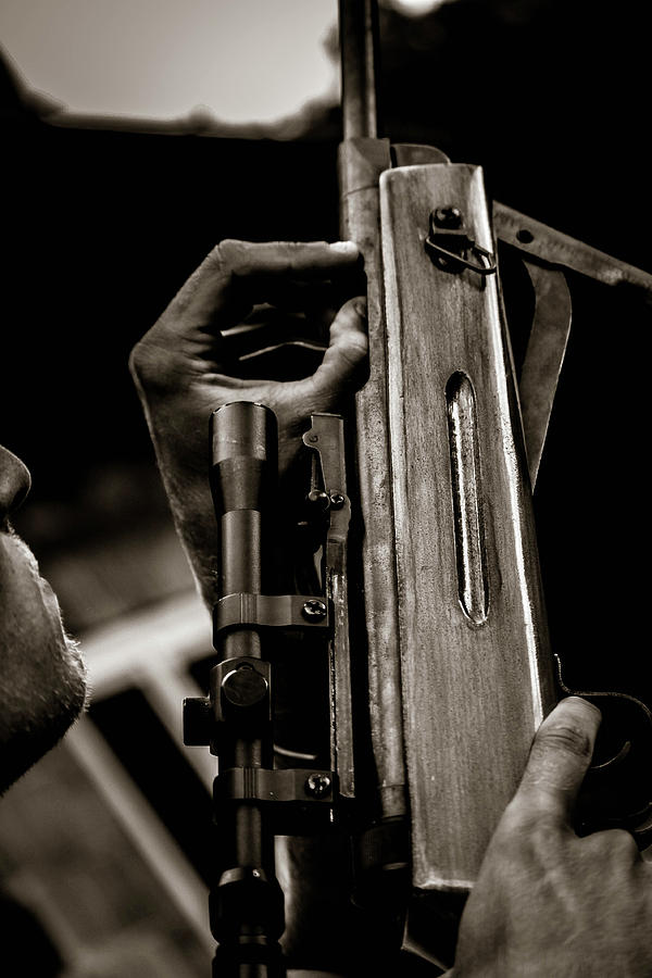 Preparing a rifle Photograph by Christopher Bajor