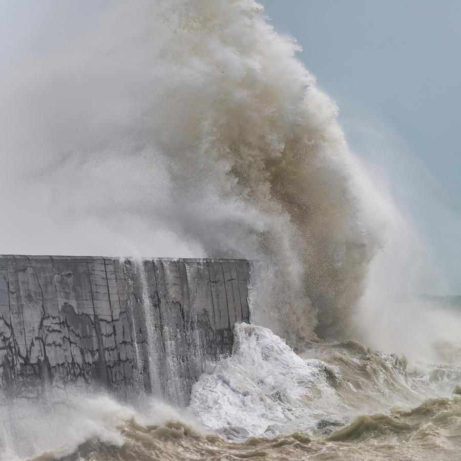 Stunning dangerous high waves crashing over harbor wall during w ...