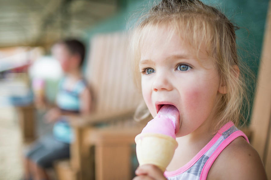 Young Cute Girl Happily Licking Pink Ice Cream On Summer Day Photograph By Cavan Images Pixels