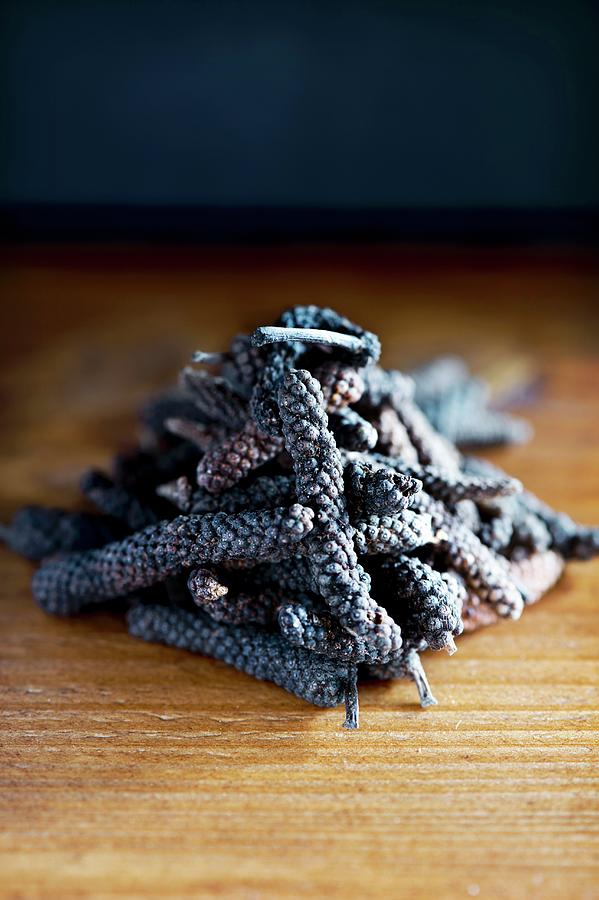 A Close-up On Long Java Pepper On A Rustic Wooden Table Photograph by Jamie Watson - Fine Art ...