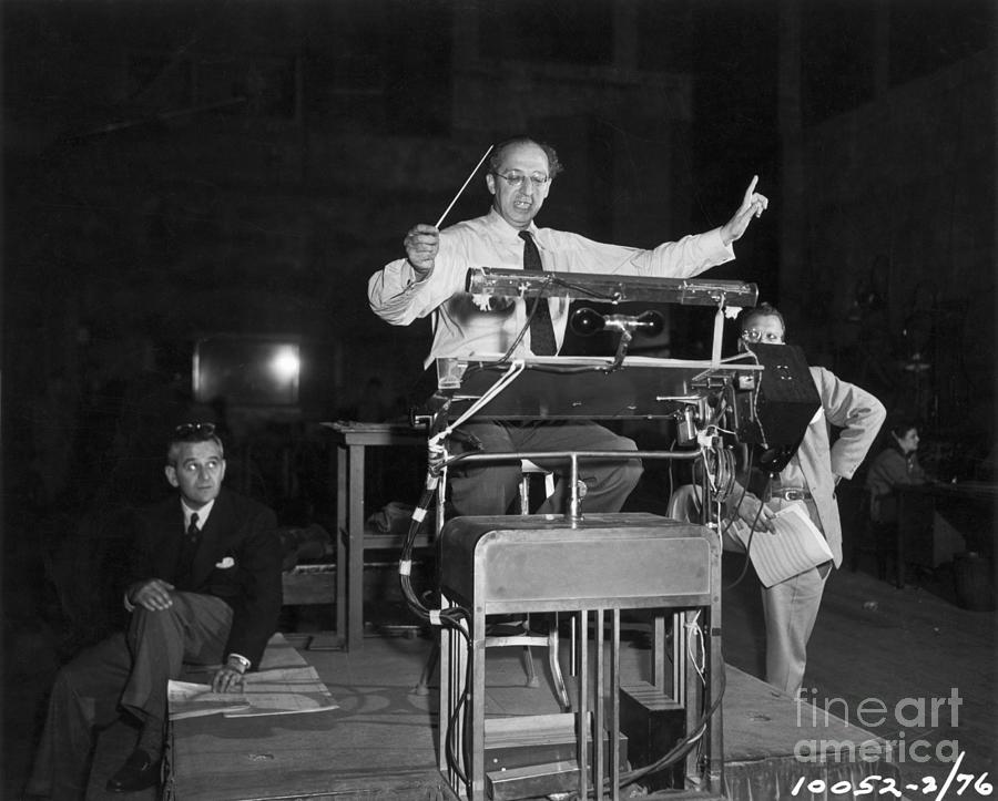 Aaron Copland Conducting Seated by Bettmann