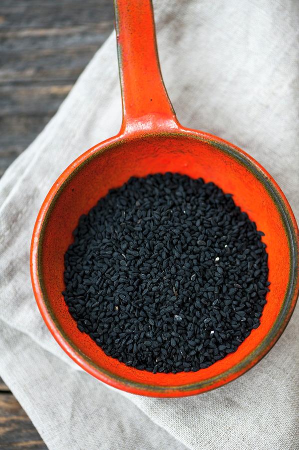 Black Cumin In An Orange Container seen From Above Photograph by ...