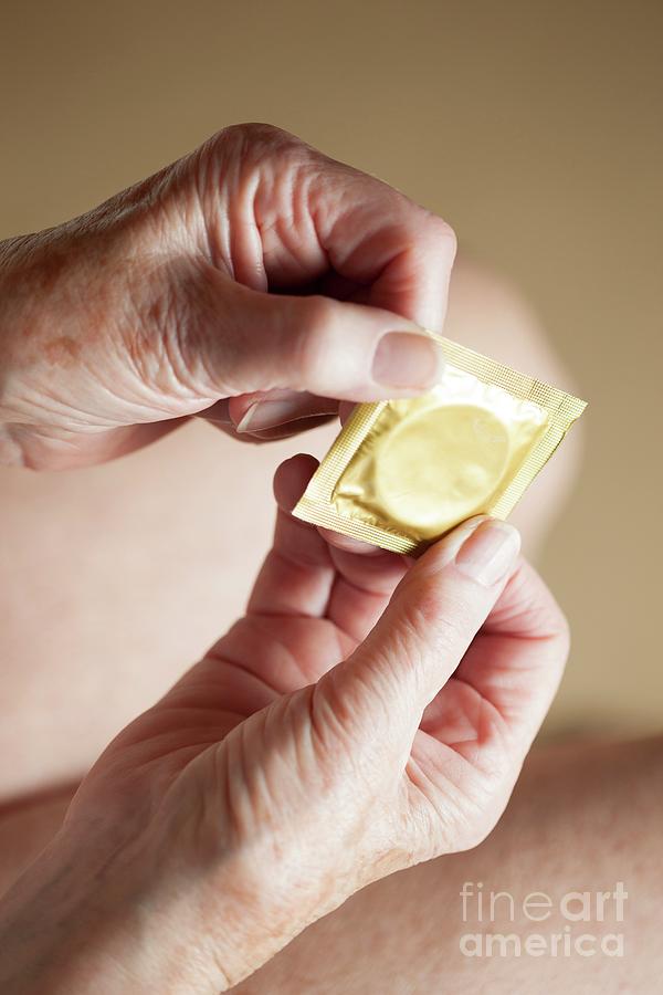 Close Up Of Elderly Woman Holding Condom Photograph By Cristina Pedrazziniscience Photo Library