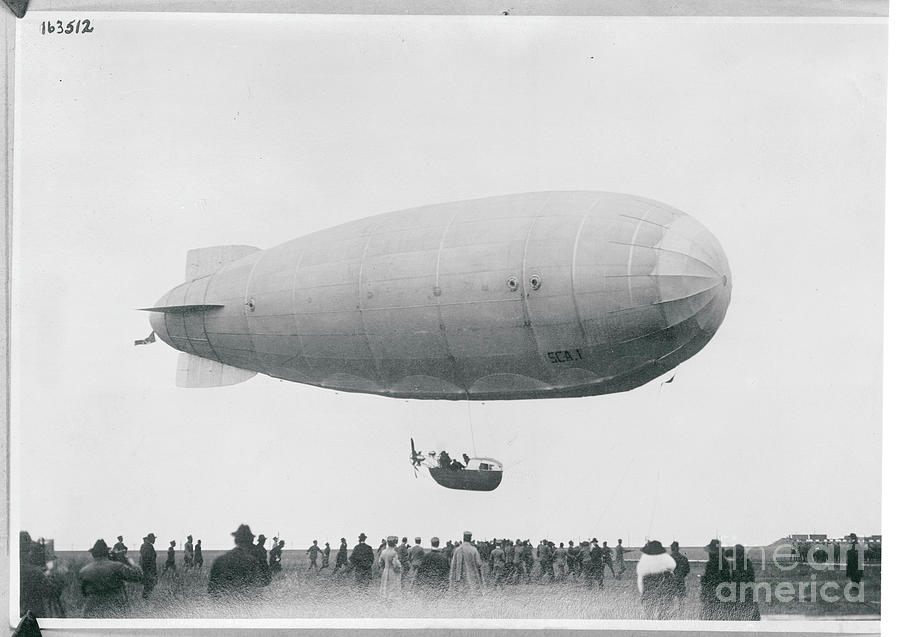 Dirigible Hovering Over Crowd by Bettmann