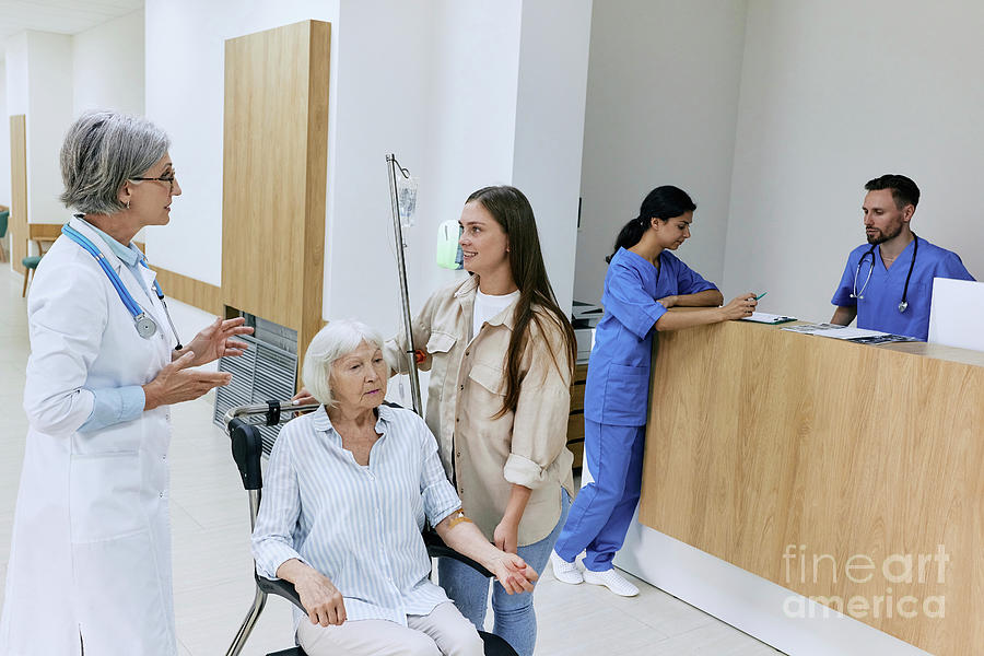 Doctor Talking To Patient's Family by Science Photo Library