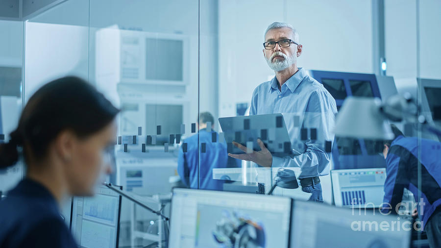 Engineer Holding A Laptop Photograph by Gorodenkoff Productions/science ...