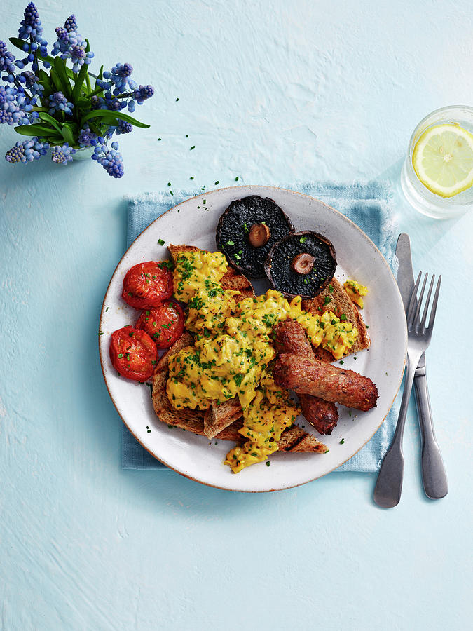 Herby Scrambled Eggs With Crostini Style Toast Vegan Sausage Mushrooms And Tomatos Photograph
