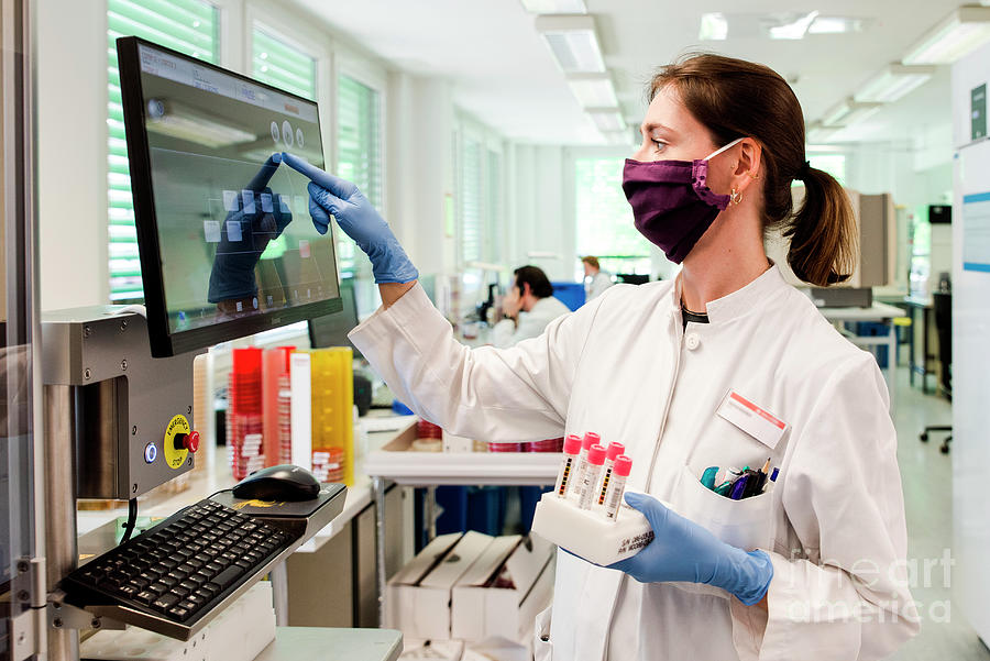 Lab Technician Operating Automated Specimen Processor by Daniela Beckmann / Science Photo Library