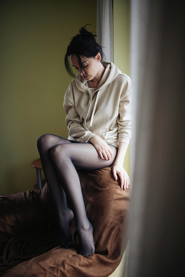 Lonely Woman In Black Tights Sitting On An Armchair Near Window. Photograph by Cavan Images ...
