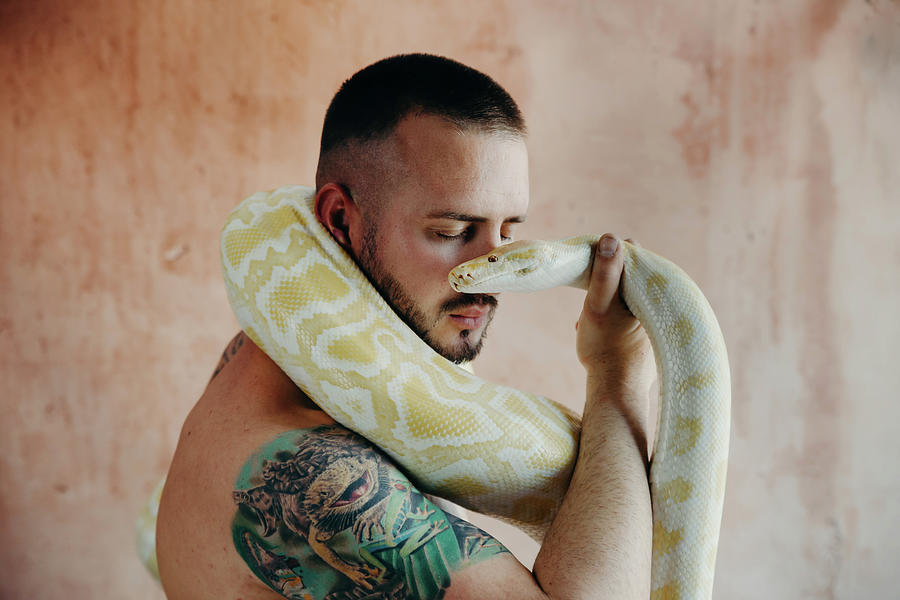 Man Holding A Python Near His Face Photograph by Cavan Images | Fine ...