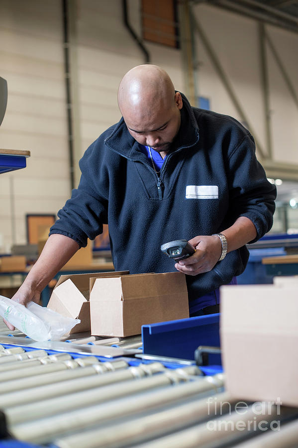 Man Using A Barcode Reader In A Warehouse Photograph by Arno Massee ...