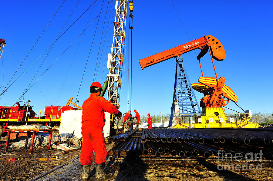 Oil Field Oil Workers At Work Photograph by Qiuju Song - Fine Art America