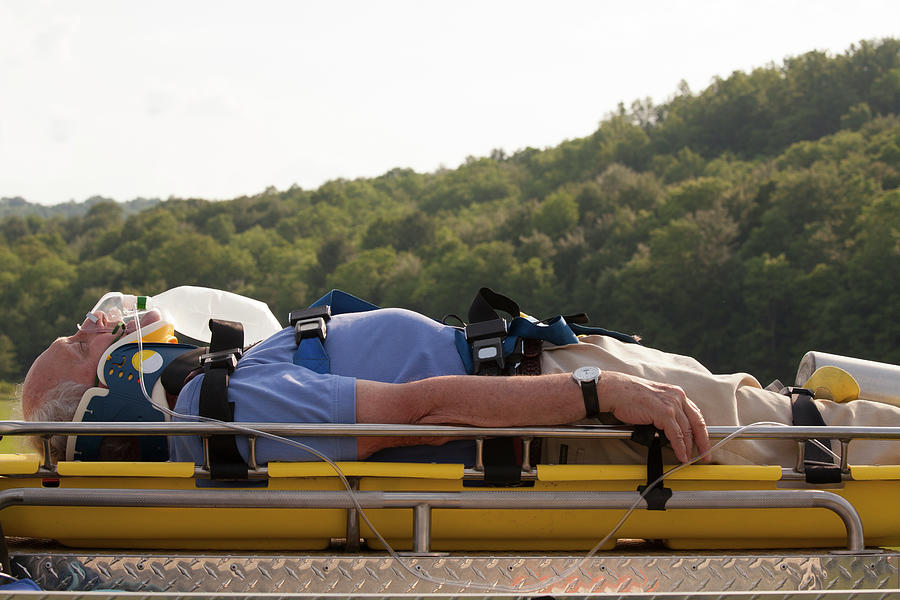 Side View Of Patient Lying On Stretcher Photograph by Cavan Images ...