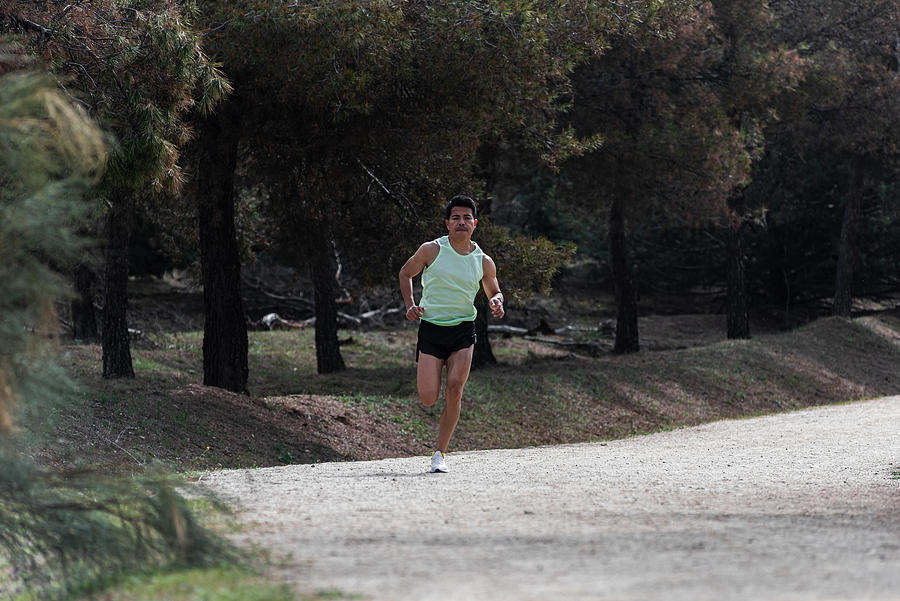 South American Man Running On A Nature Trail In The Forest Photograph ...