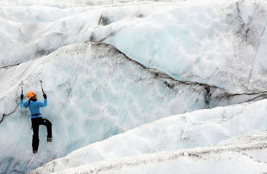 Woman Climbing Ice Wall On Sólheimajökull Glacier In Iceland Photograph ...