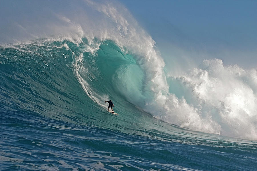 A tow-in surfer drops to the curl of Hawaii Photograph by David ...