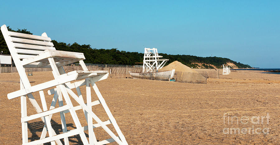 Lifeguard stands and a rescue boat on an empty beach Photograph by ...