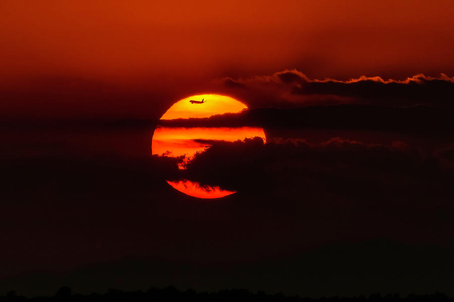 Red sun setting with an airplane silhouette Photograph by John Price ...