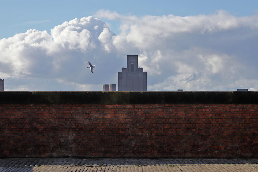 River Mersey flowing behind a red brick wall Photograph by Spyros ...