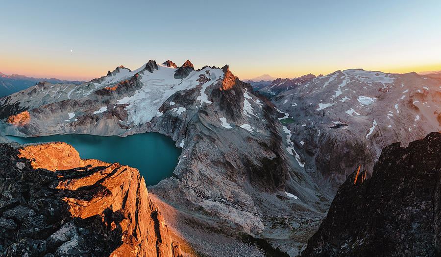 Sunrise from Dip Top Peak overlooking Pea Soup Lake across from glaciated Mount Daniel ...